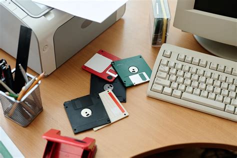 Premium Photo Retro Workstation Featuring Floppy Disks And Keyboard