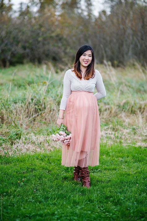 Portrait Of Pregnant Asian Woman Outdoor In A Park By Stocksy