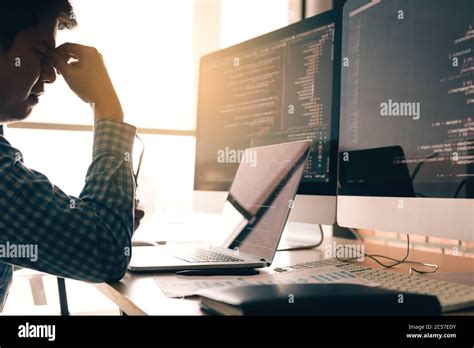 Man Programmers Are Stressed And Hand Holding Nose With Headache At The