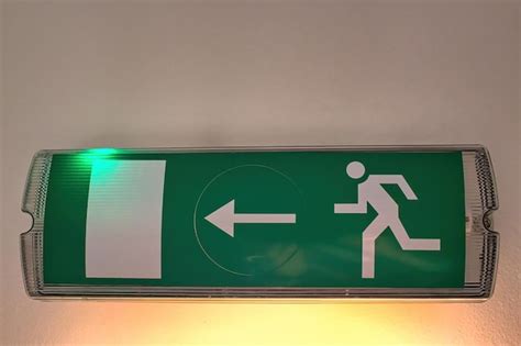 Premium Photo Closeup Of An Emergency Exit Sign On The Wall