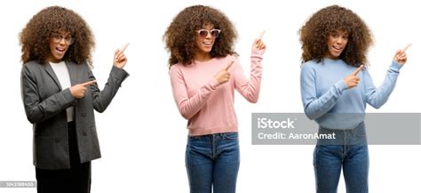 아프리카계 미국인 젊은 여자는 웃 고 옆에 두 손과 손가락으로 가리키는 카메라를 보고 다른 의상을 입고 가리키기에 대한 스톡 사진 및 기타 이미지 Istock