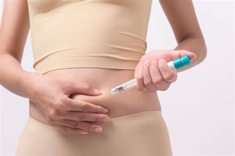 Premium Photo Close Up Woman Using Ivf Treatment Injection On Belly