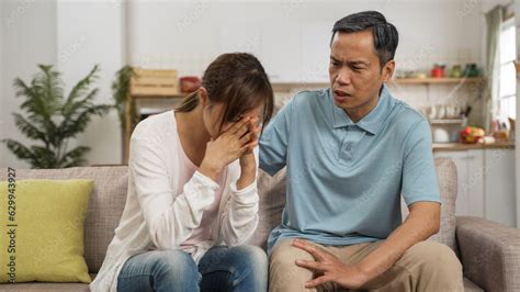 Asian Japanese Grandfather Trying To Comfort And Encourage Sad Adult