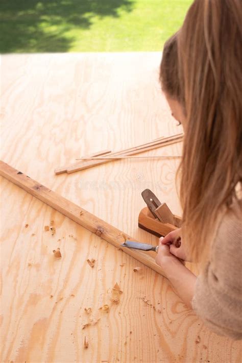 Craftswoman Carving Wood With Chisel Concentrated Female Joiner In