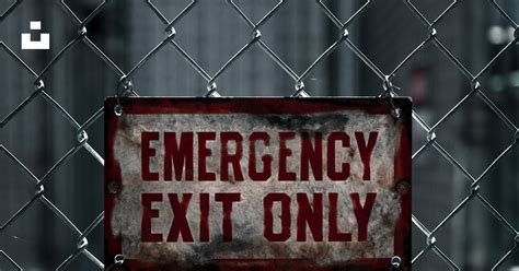 A Red Emergency Exit Only Sign On A Chain Link Fence Photo Free Sign