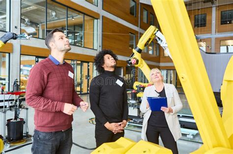 Engineers And Scientists Discussing Robotics Technology In An