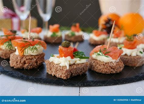 Smoked Salmon Canapes With Cheese Cream And Capers On Rye Bread Stock