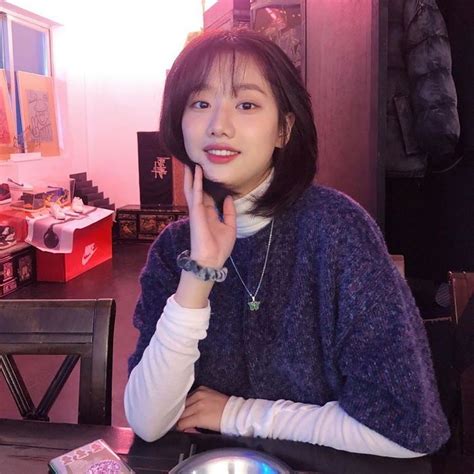 A Woman Sitting At A Table With A Computer Mouse