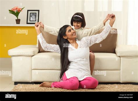 Girl Playing With Her Mother Stock Photo Alamy