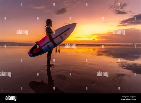 View Of Surfboarder On Kuta Beach At Sunset Kuta Bali Indonesia