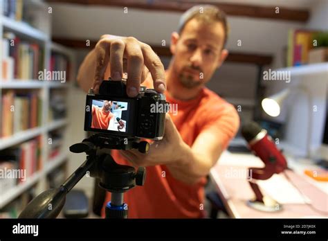 Mid Adult Man Adjusting Camera For Recording Video Tutorial Stock Photo Alamy