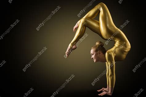Flexible Woman Gymnast Doing Yoga Stretching Pose Standing On Hands