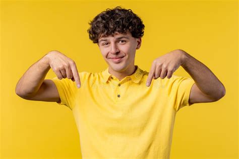Happy Man Pointing Down To Advertising Area Yellow Background Young