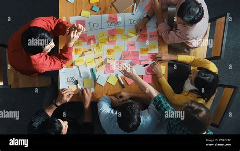 Top View Of People Writing And Making Scrum Task Board While Writing