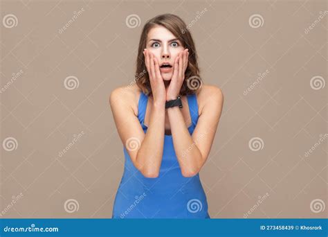 Shocked Surprised Beautiful Woman Standing With Palms On Her Cheeks