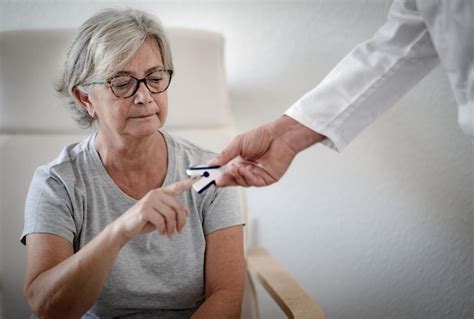 Premium Photo Doctor Measure Blood Oxygen Saturation In A Senior Patient Woman
