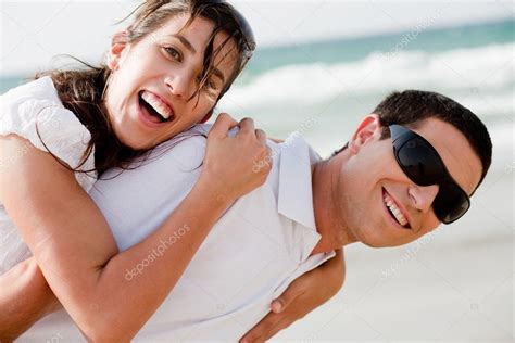 Couple Smiling On The Beach Stock Photo Get Net
