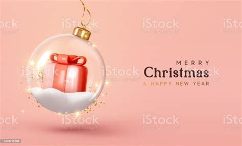 메리 크리스마스와 새해 복 많이 받으세요 크리스마스 장식품은 눈 위에 선물 상자 측면이 있는 유리 투명 공입니다 골드 리본에 매달려있는 크리스마스 공입니다 휴일 크리스마스