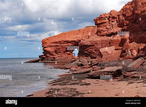 Red Sandstone Cliff With Cave On North Coast Of Prince Edward Island