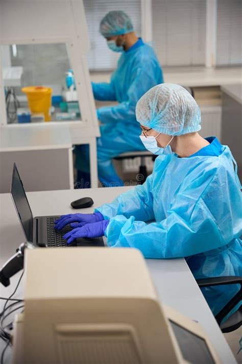 Laboratory Employee Enters Research Results Into The Database Stock