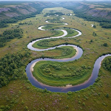 Aerial View Of A Meandering River Winding Through A Lush Expansive