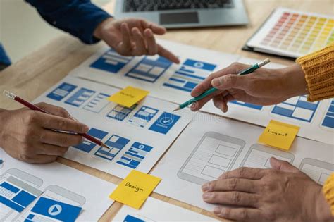 A Team Of UX Designers Works On A New Website Layout Plan Mobile Web Application Development In