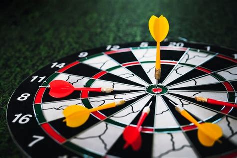 premium photo close up shot of a dart board darts arrow missing the target on a dart board