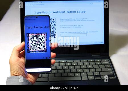 A Person Scans A QR Code With The Google Authenticator App On Their Smartphone To Setup Two