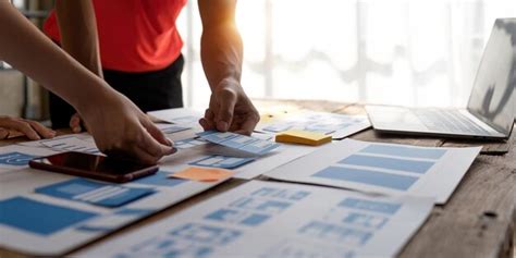 Premium Photo Close Up Ux Developer And Ui Designer Brainstorming About Mobile App Interface