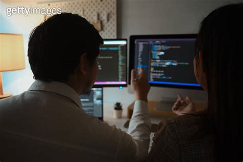 Male And Female Web Developers Working With Coded Data On Computer Screen 1815993113 게티이미지뱅크