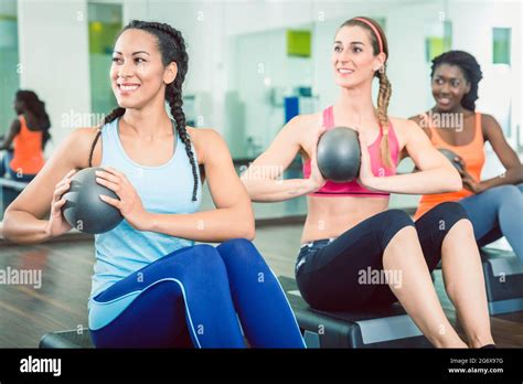Beautiful Young Woman Exercising Russian Twist With Med Ball From Sitting Position For Strong