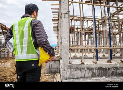 Asian Business Man Construction Engineer Worker In Protective Helmet