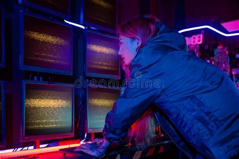 asian woman wearing a black jacket hacking programming system and working with stock image