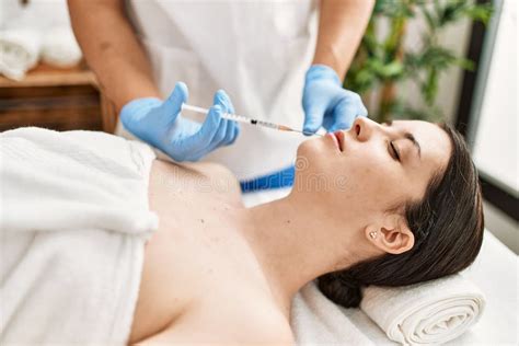 Doctor Man Injecting Botox On Woman Lips For Anti Aging Treatment At