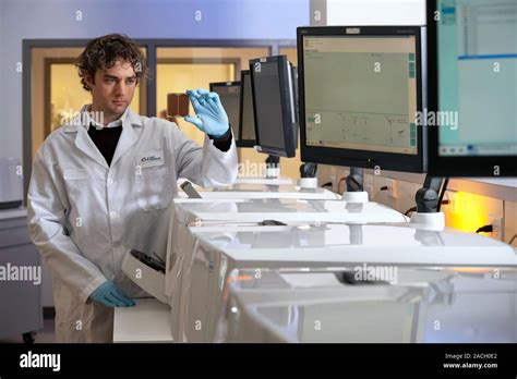 Dna Sequencers Technician Next To A Row Of Gs Flx Sequencing Machines At 454 Life Sciences
