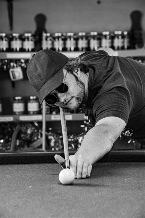 Focused Young Man Playing Pool In A Relaxed Setting Stock Image Image Of Footwear Leaning