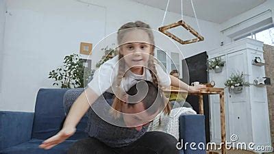 Dad Play With His Daughter At Home On The Couch Stay Home Quarantine Lockdown A Happy Family