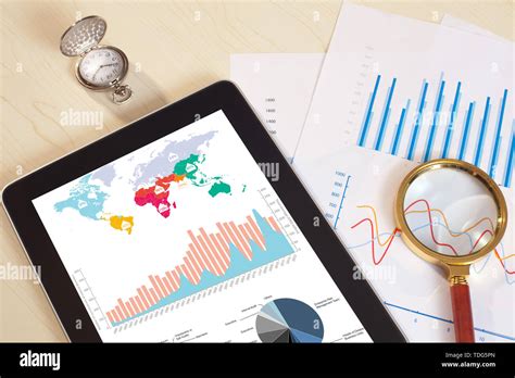 Digital Tablet And Smartphone With Financial Chart Report Paper Stock