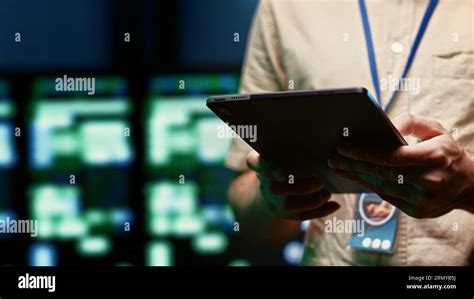 Serviceman Verifying Maintenance Checklist In High Tech Facility Supporting Ai Through High