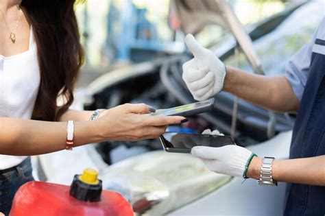 Premium Photo Asian Women Get Contact Numbers From Auto Mechanics After Fixing The Car Engine