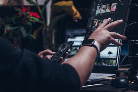 Premium Photo Midsection Of Man Multi Tasking With Mobile Phone And Laptop In The Room At Night