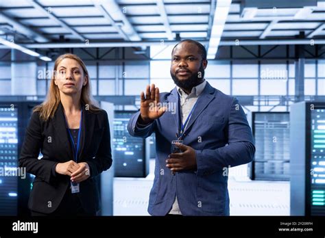 Teamworking Engineers In Server Room Using Ar Tech To Implement And Maintain Security Measures