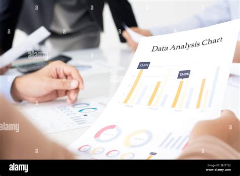 business people discussing and analyzing graph data at the meeting