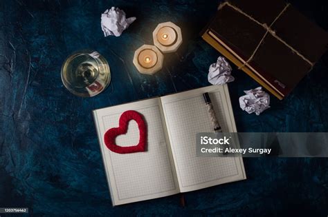 화이트 와인의 유리 명확한 일기 펜 양초 구겨진 종이 심장 어두운 파란색 배경에 책의 스택 로맨틱 한 개념 공간을 복사합니다
