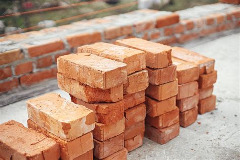 Premium Photo Stack Of Red Bricks On Concrete Foundation Process Of