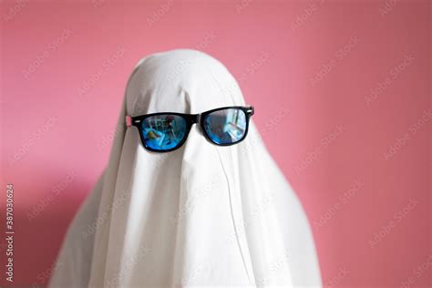 Cute Sheet Ghost Costume With Sunglasses On A Pink Background