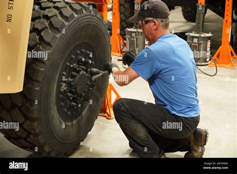 A Babe Taking The JLTV Phase II Course Tightens The Tire Lug Nuts Army Photo By Cheryl