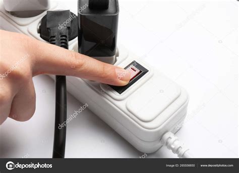 Woman Pressing Power Button Of Extension Cord On White Background Closeup Electrician S