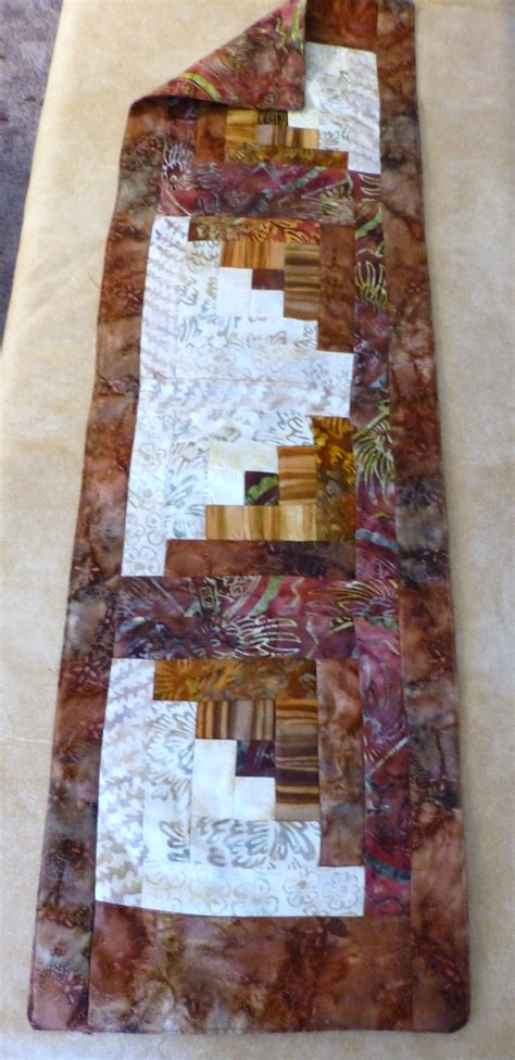 This Quilted Tablerunner Is Done In Shades Of Brown And Creams It Is In The Log Cabin Pattern