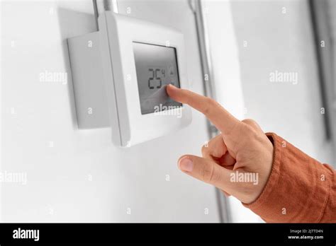 Hand Setting Room Temperature On Sensor At Home Stock Photo Alamy